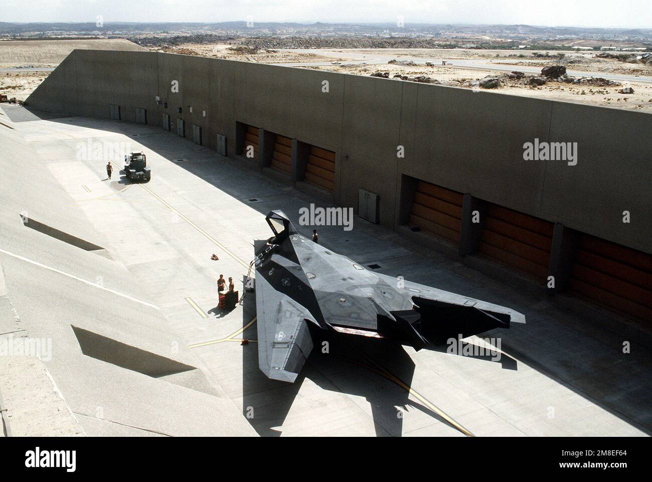 Ground crewmen service a 37th Tactical Fighter Wing F-117A aircraft ...
