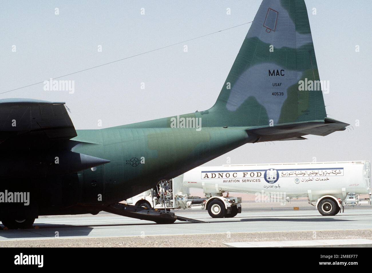 A commercial tractor-trailer carrying aviation fuel passes the tail of ...