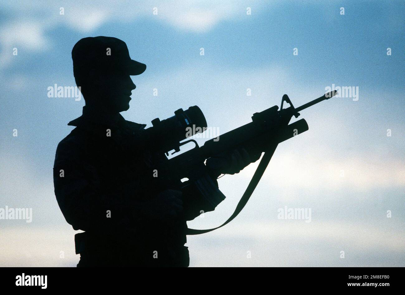 An Air Force security policeman armed with an M-16 rifle equipped with ...