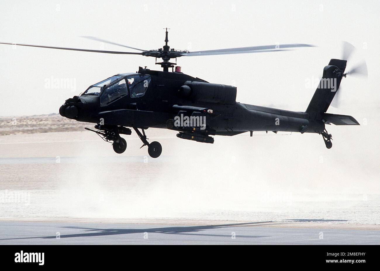 An AH-64 Apache helicopter takes off from an air base during Operation ...
