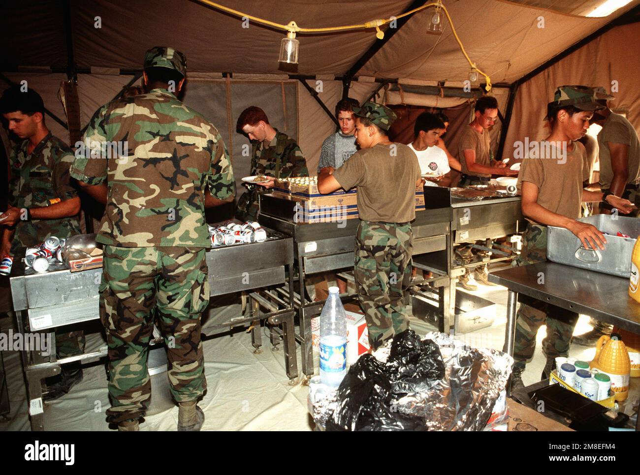 Airmen break for a meal in a chow tent during Operation Desert Shield. Subject Operation/Series ...