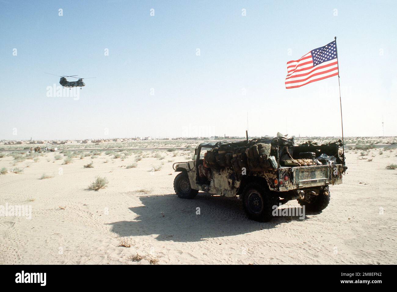 The American flag flies from an M998 High-Mobility Multipurpose Wheeled ...