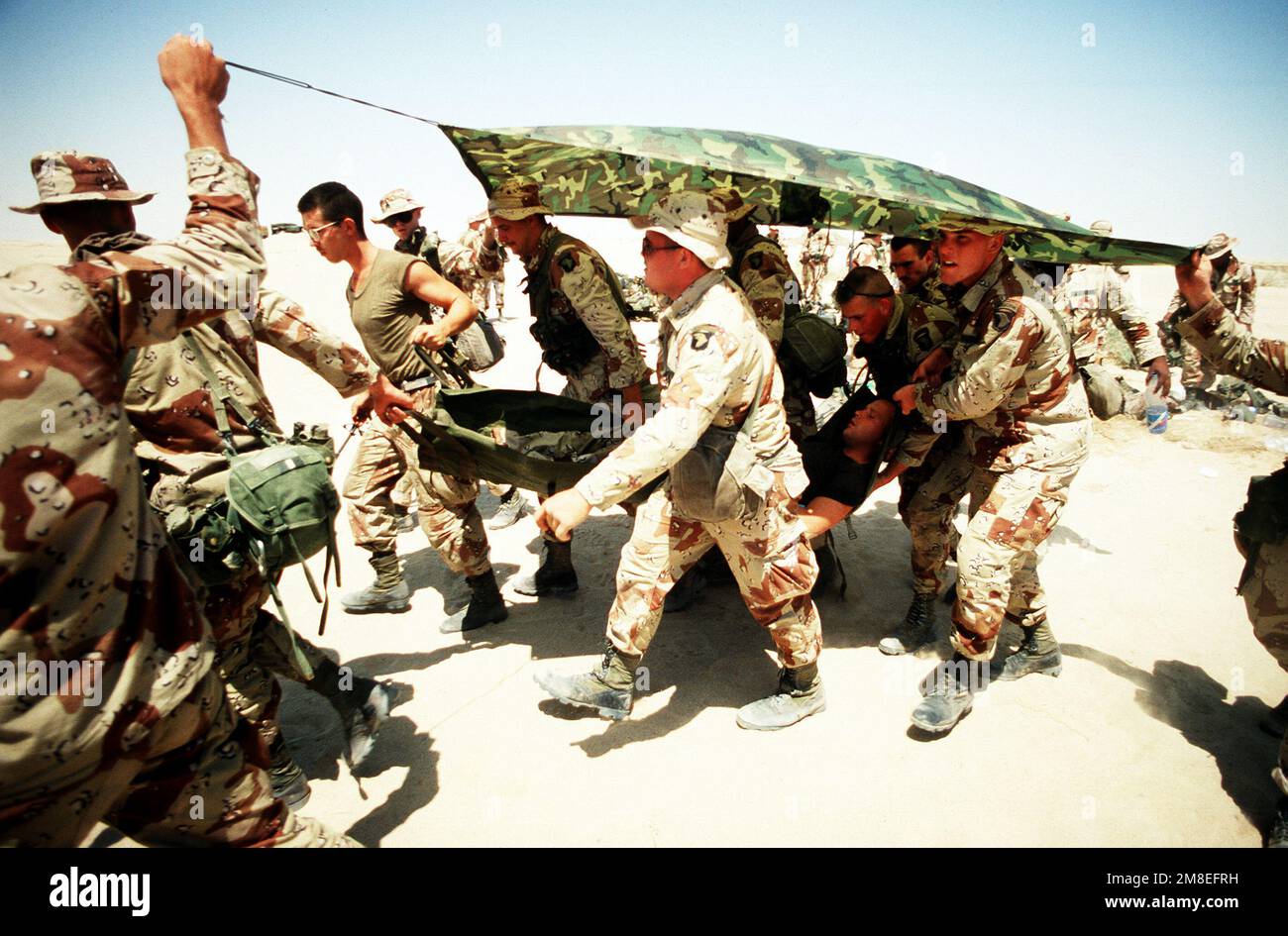 Members of the 101st Airborne Division transport a heat stroke victim on a litter during ...
