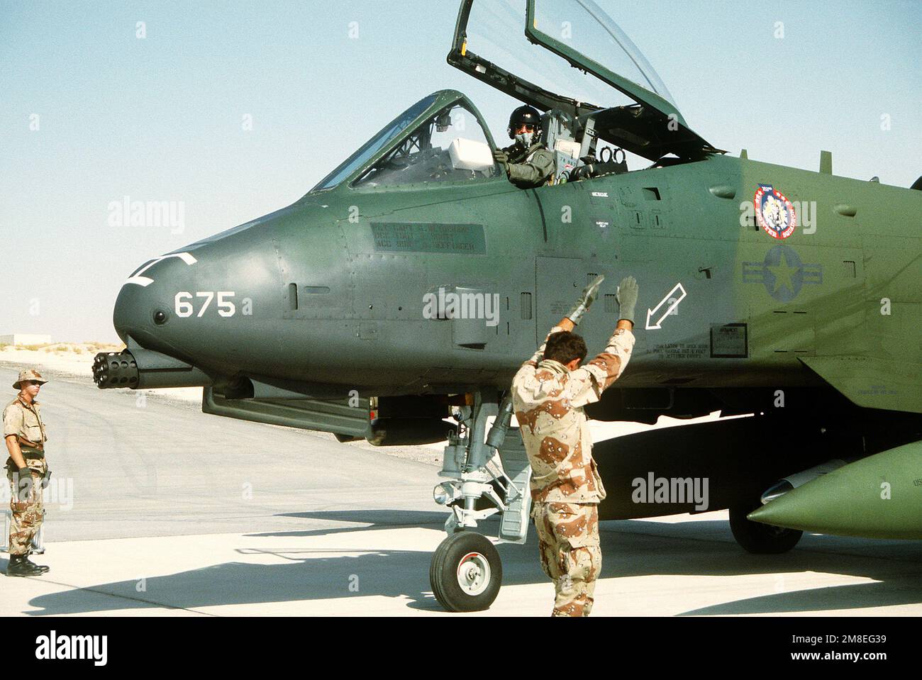 A ground crewman signals as the pilot of a 353rd Tactical Fighter ...