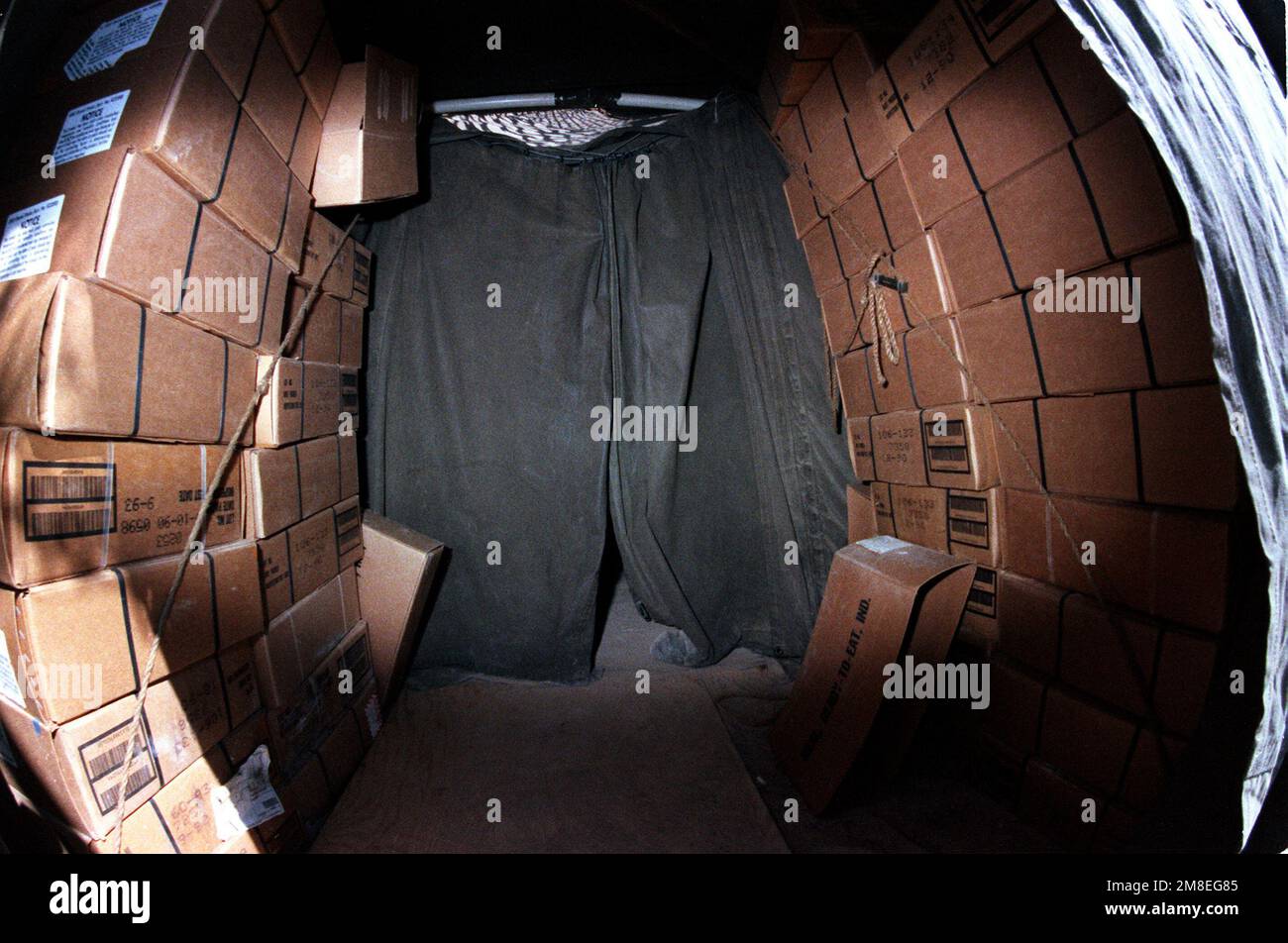 Cases of meals, ready-to-eat (MREs) fill the entrance to the G-3 tent ...
