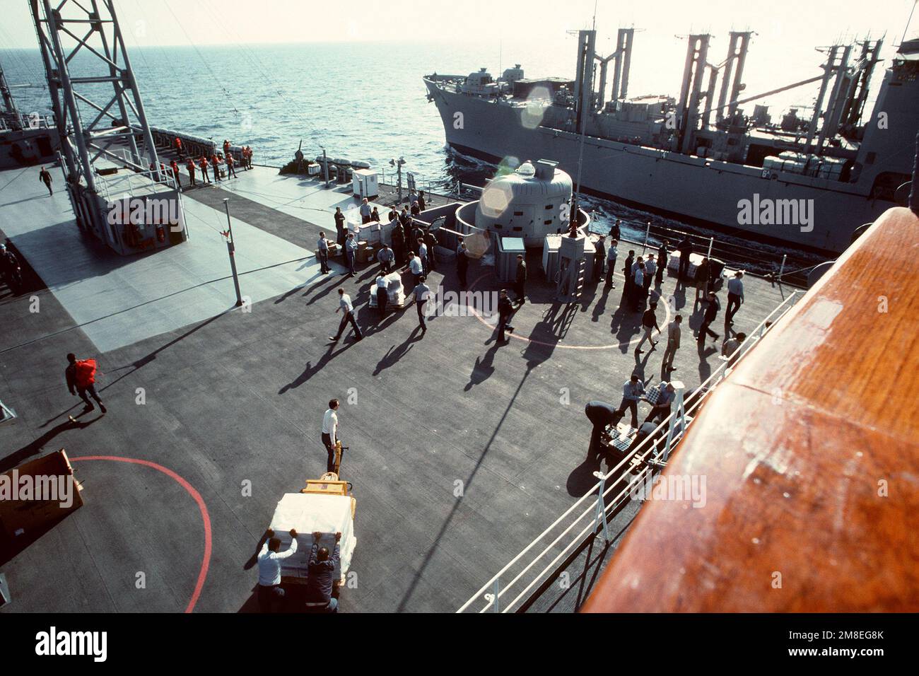 Sailors assigned to working parties wait for instructions as the ...