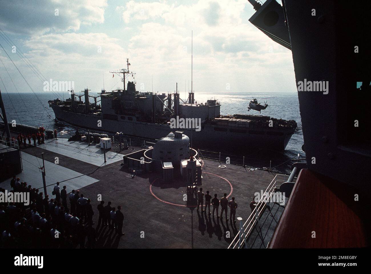 Sailors mustered for a working party stand in formation aboard the ...