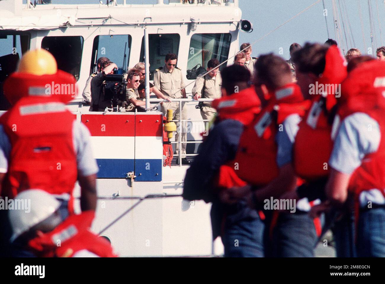 Sailors aboard the amphibious command ship USS BLUE RIDGE (LCC-19) tend ...