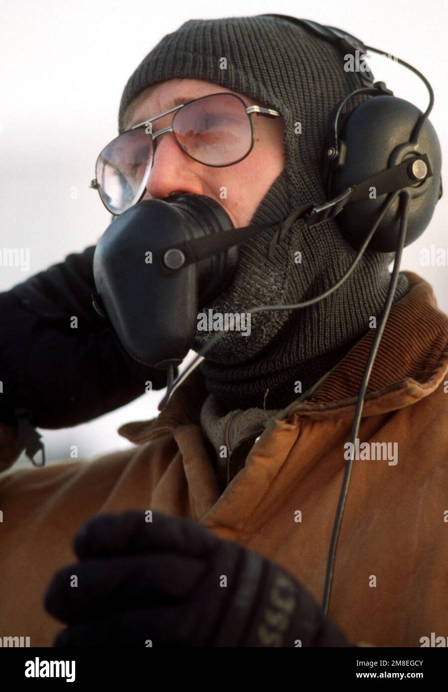 An airman on the flight line speaks with the pilot of an aircraft on a ...