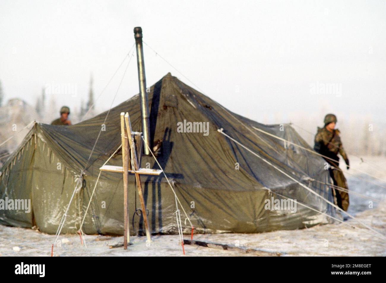 A soldier from the 6th Infantry Division (Light) walks outside of his ...