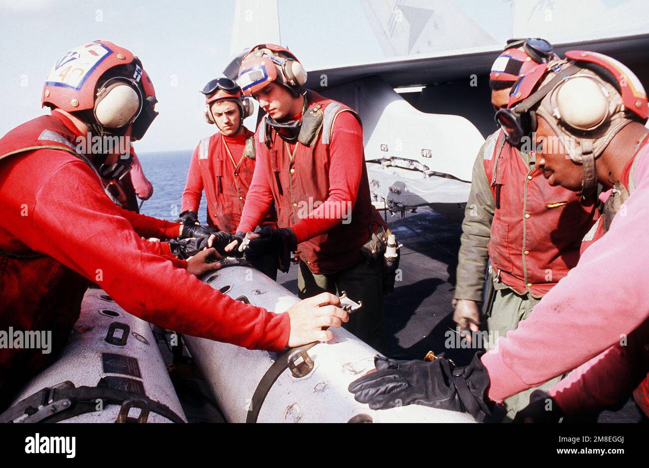 Aviation ordnancemen prepare to arm a Strike Fighter Squadron 81 (VFA ...