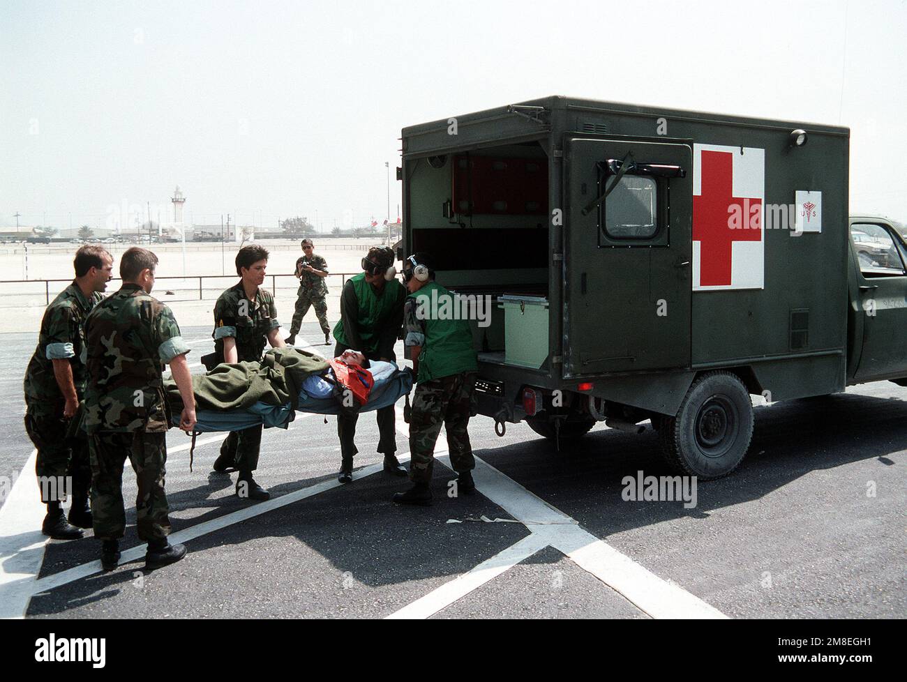 Litter bearers place a patient aboard an M-1010 tactical ambulance ...