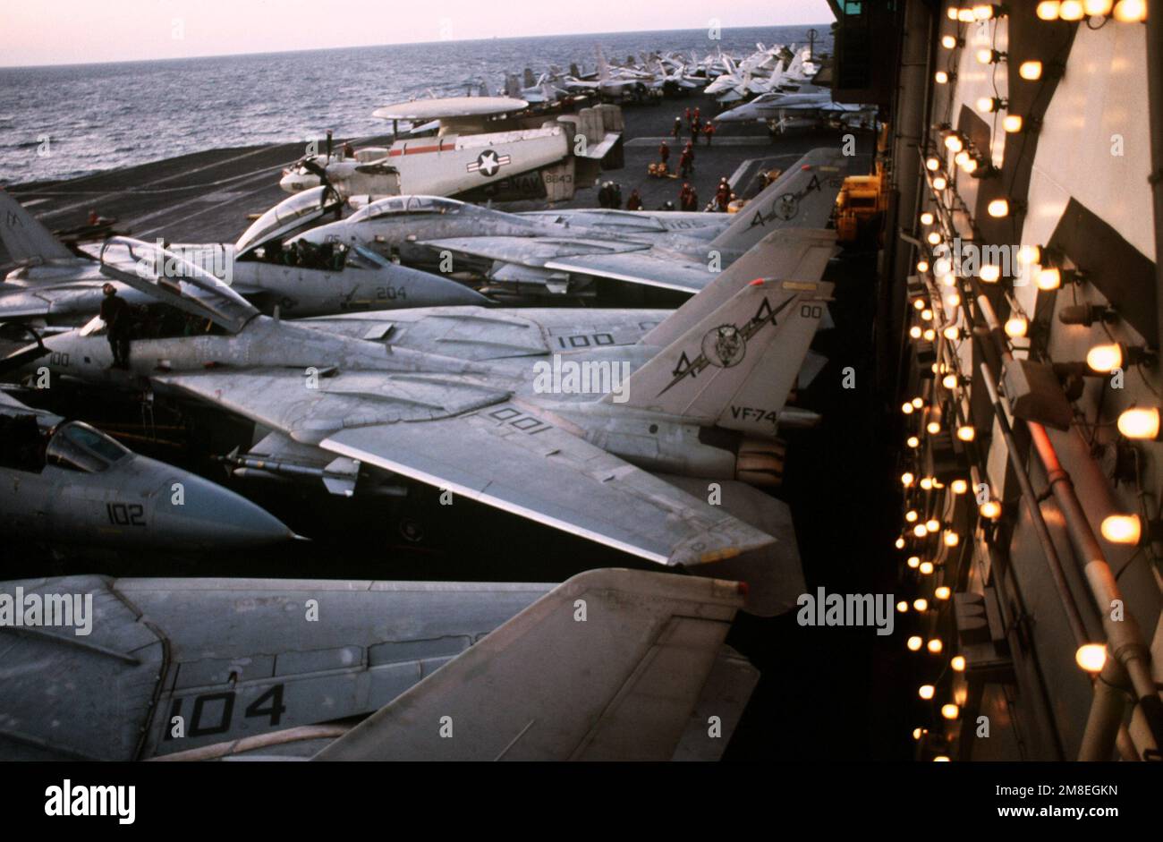 Flight deck crewmen service Fighter Squadron 74 (VF-74) F-14A Plus ...