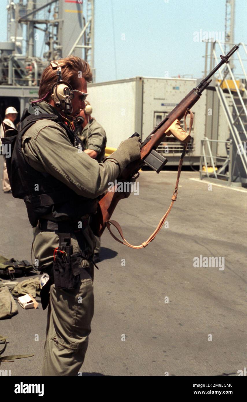 A member of Sea-Air-Land (SEAL) Team 8 checks his 7.62mm M-14 rifle ...