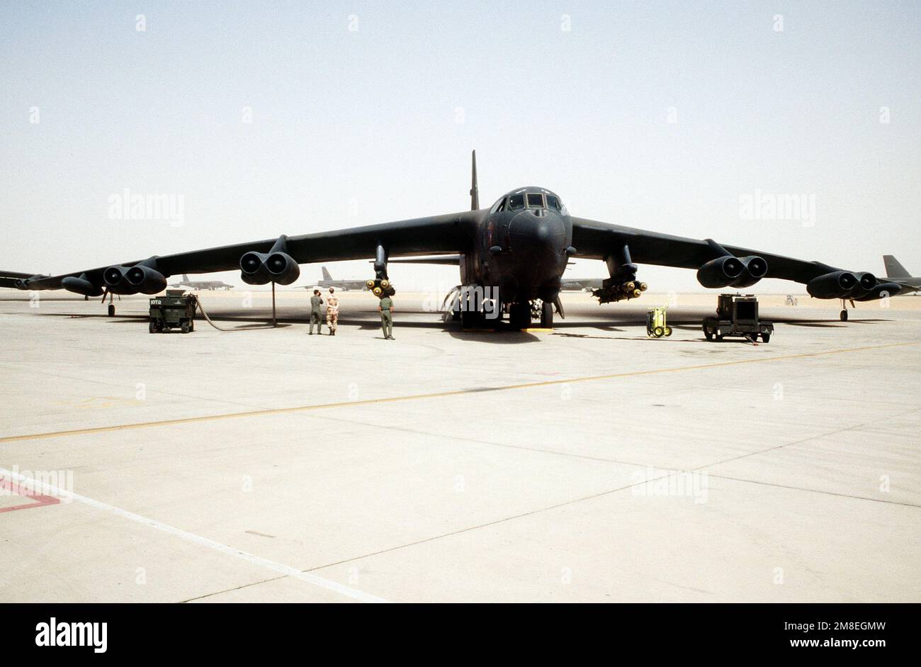 A B-52G Stratofortress aircraft is serviced on the flight line prior to ...