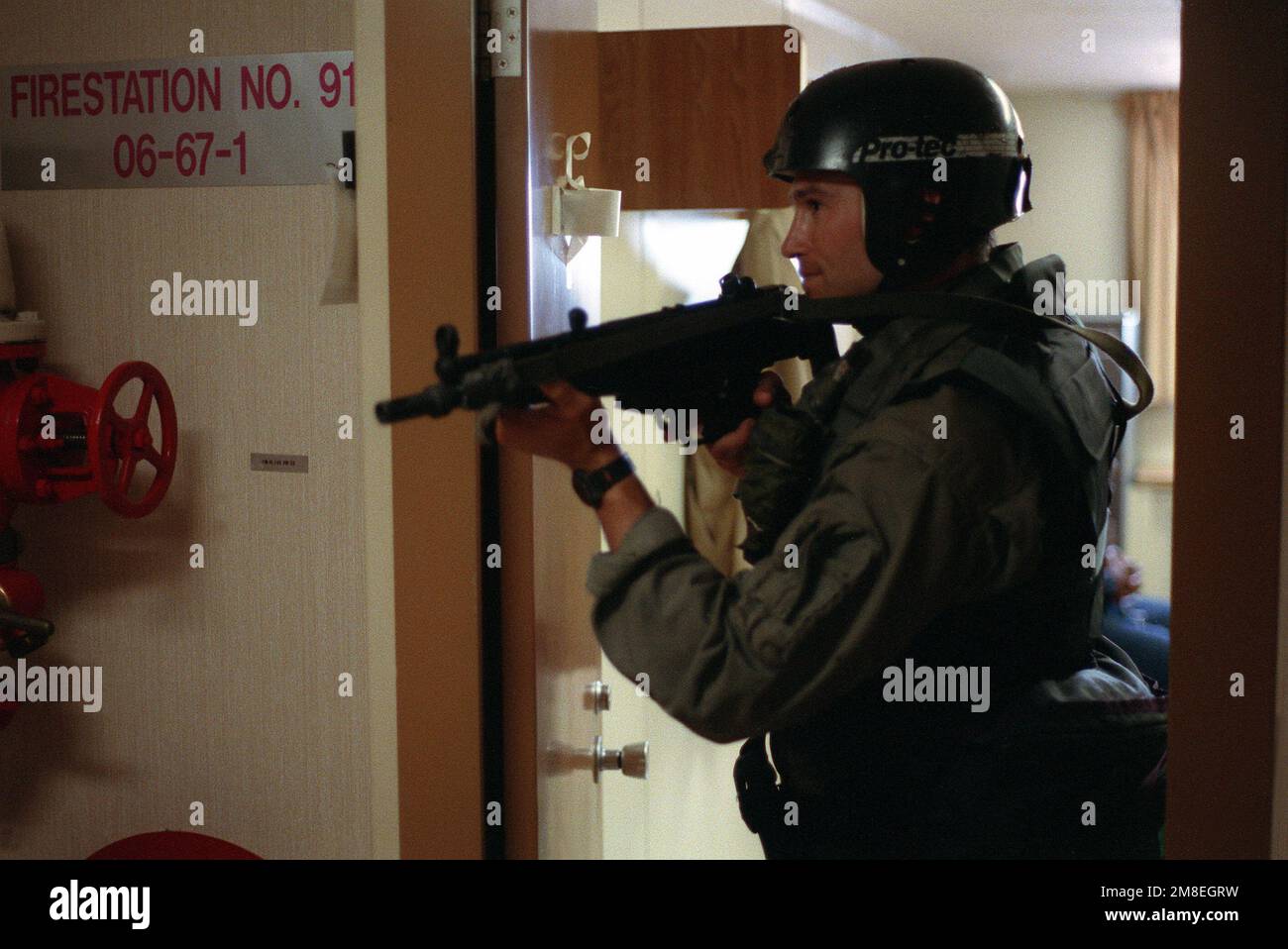 A member of Sea-Air-Land (SEAL) Team 8 keeps his 9mm MP-5A5E submachine ...