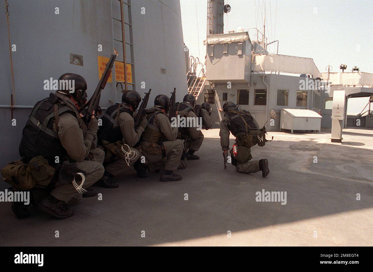 Members of Sea-Air-Land (SEAL) Team 8 prepare to assault the bridge of ...