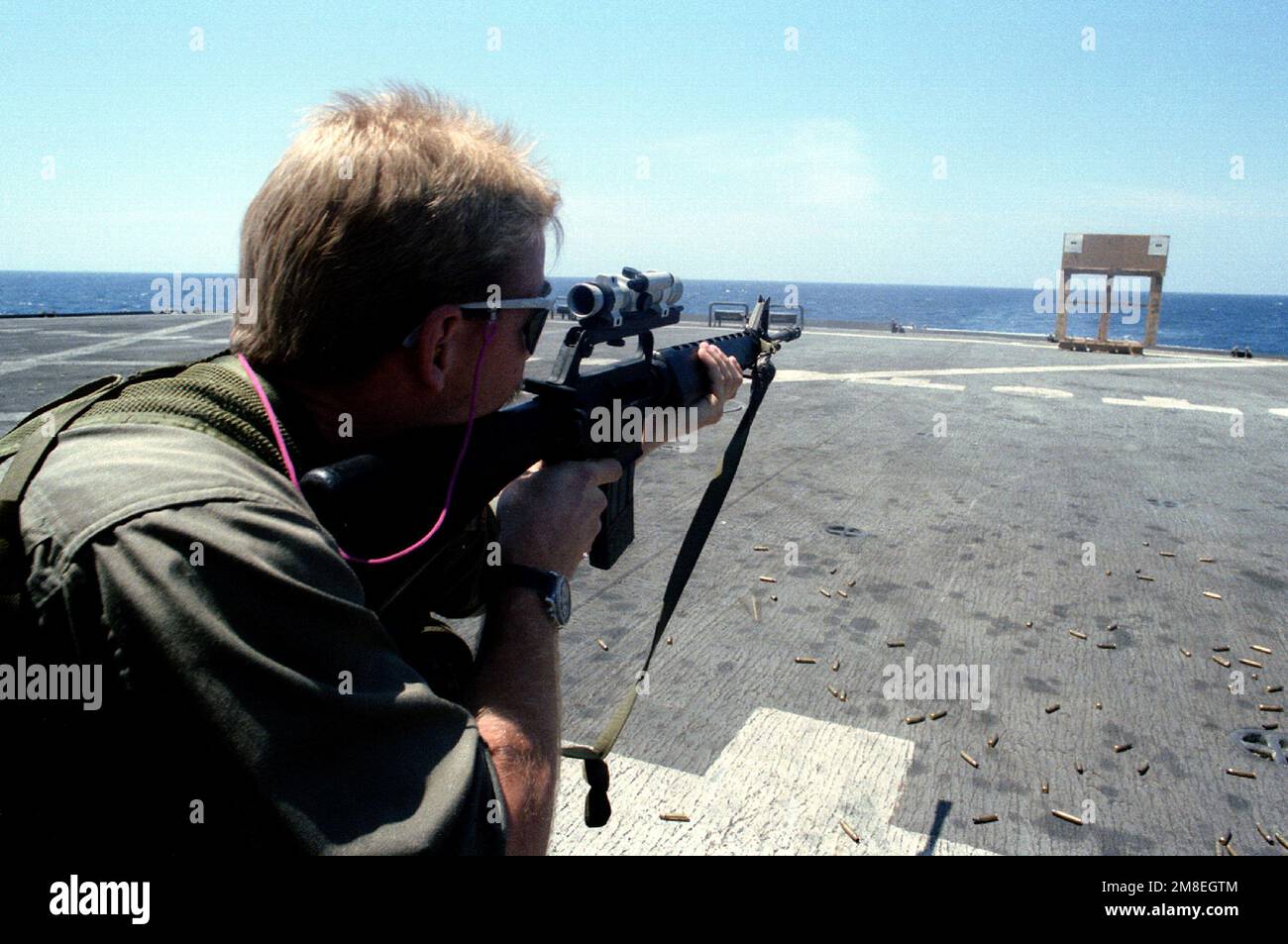 A member of Sea-Air-Land (SEAL) Team 8 fires his optical scope-equipped ...