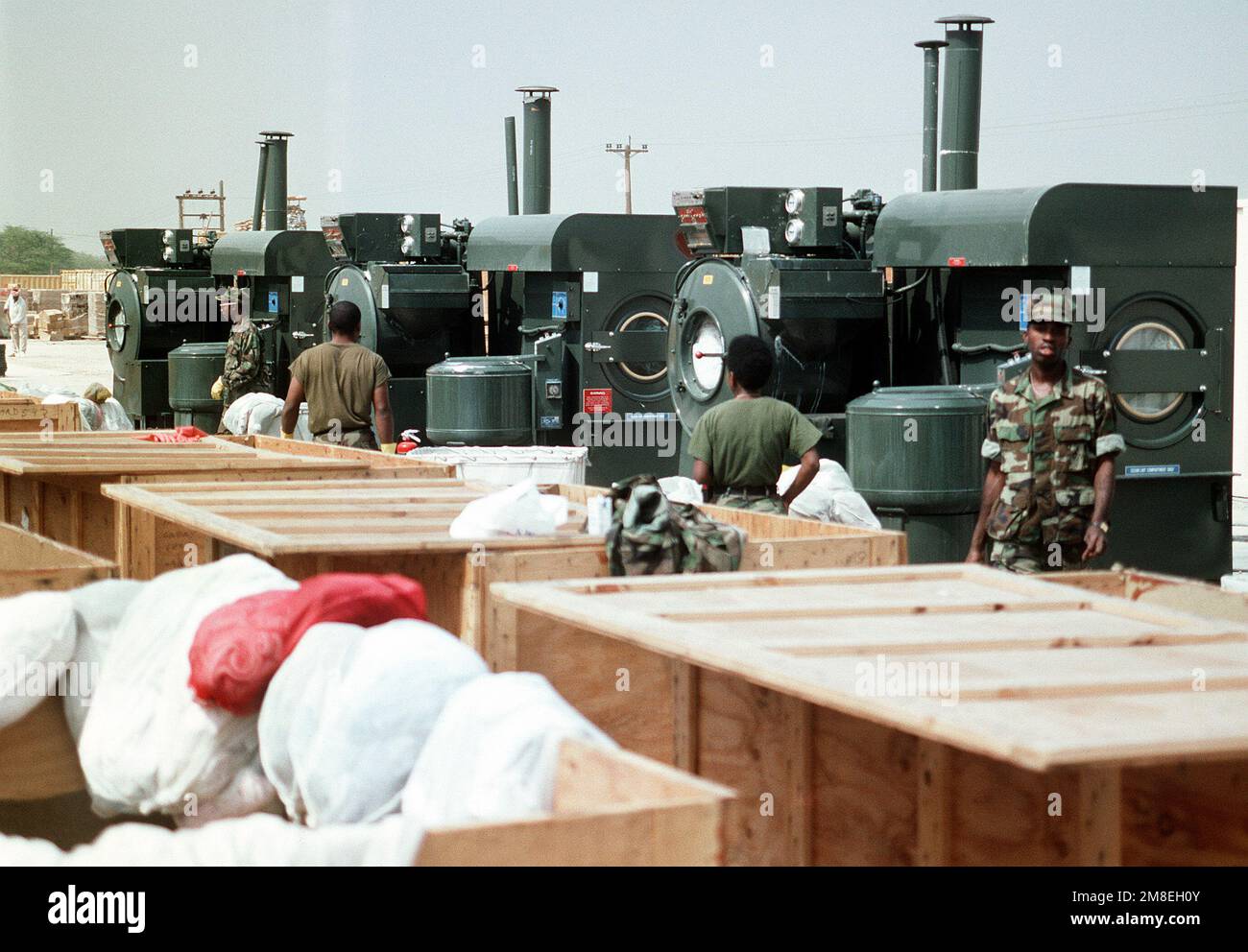 Sailors work in the Fleet Hospital Six laundry during Operation Desert ...
