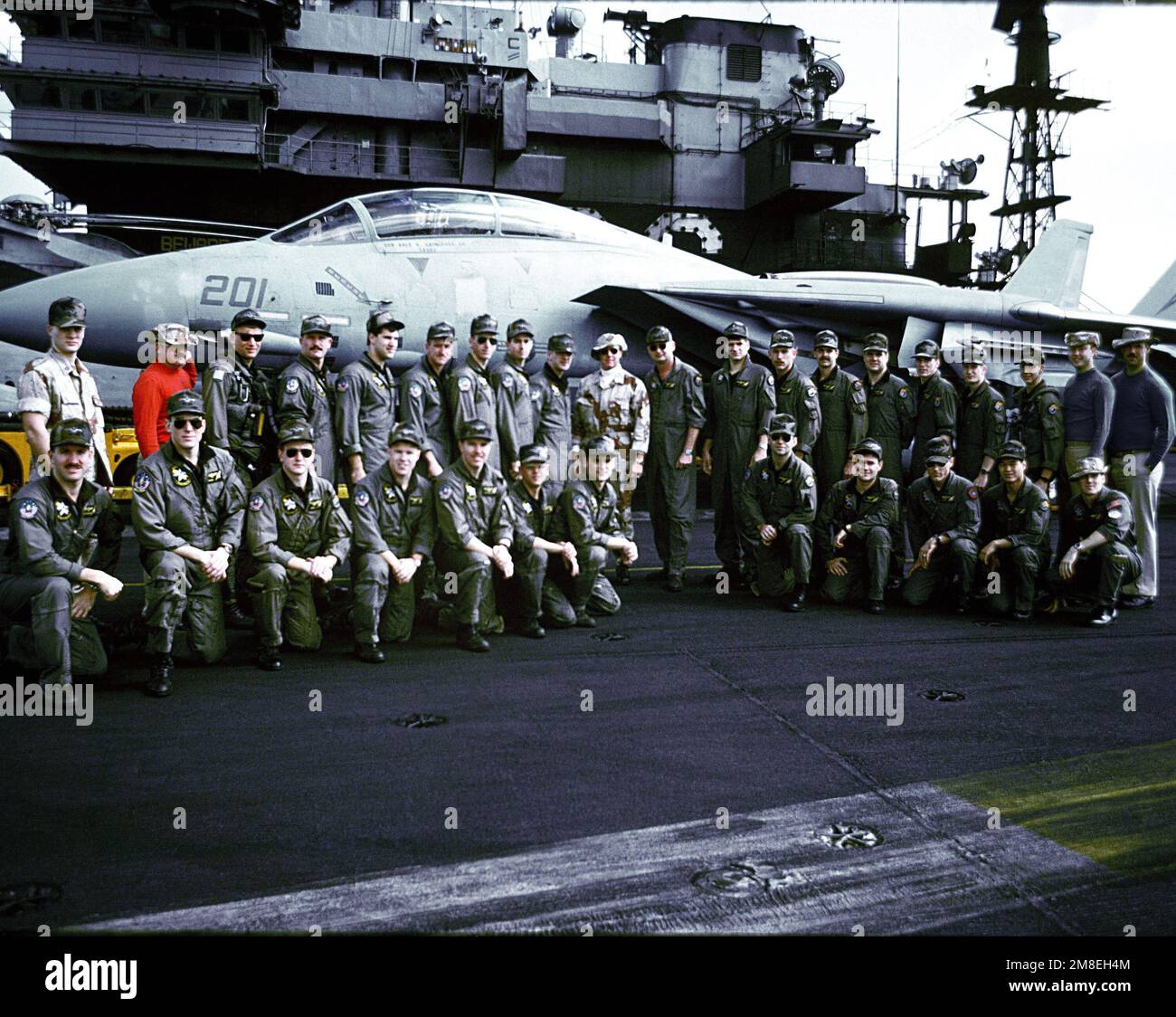 The officers of Fighter Squadron 33 (VF-33) gather in front of one of ...