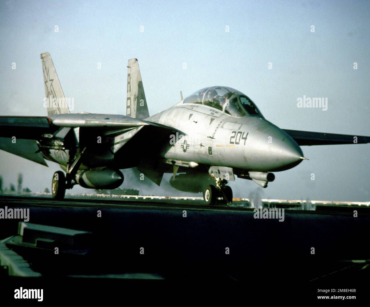 A Fighter Squadron 33 (VF-33) F-14A Tomcat aircraft stands by for ...