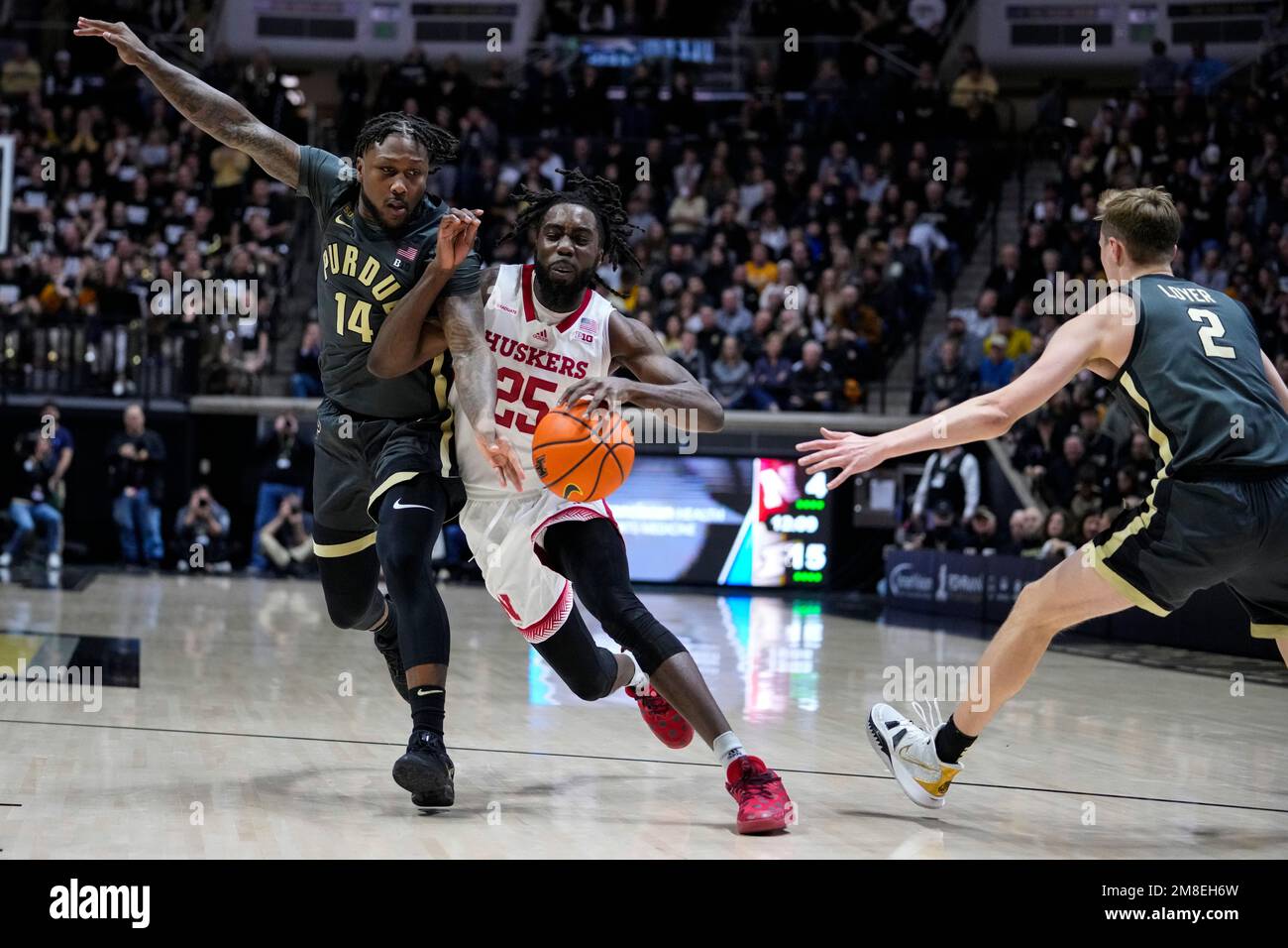 Nebraska guard Emmanuel Bandoumel (25) drives between Purdue guard ...