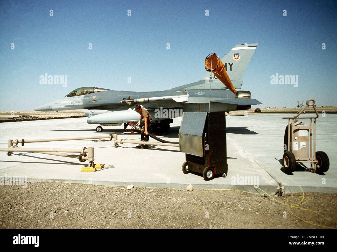 A ground crew member refuels a 347th Tactical Fighter Wing F-16C ...
