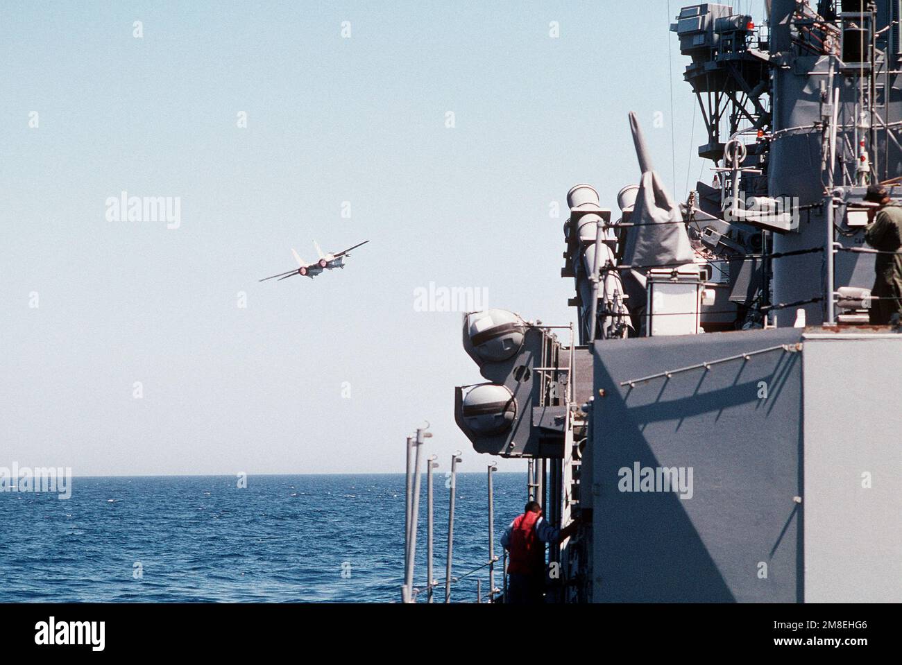 An F-14A Tomcat aircraft of Fighter Squadron 102 (VF-102) flies near ...