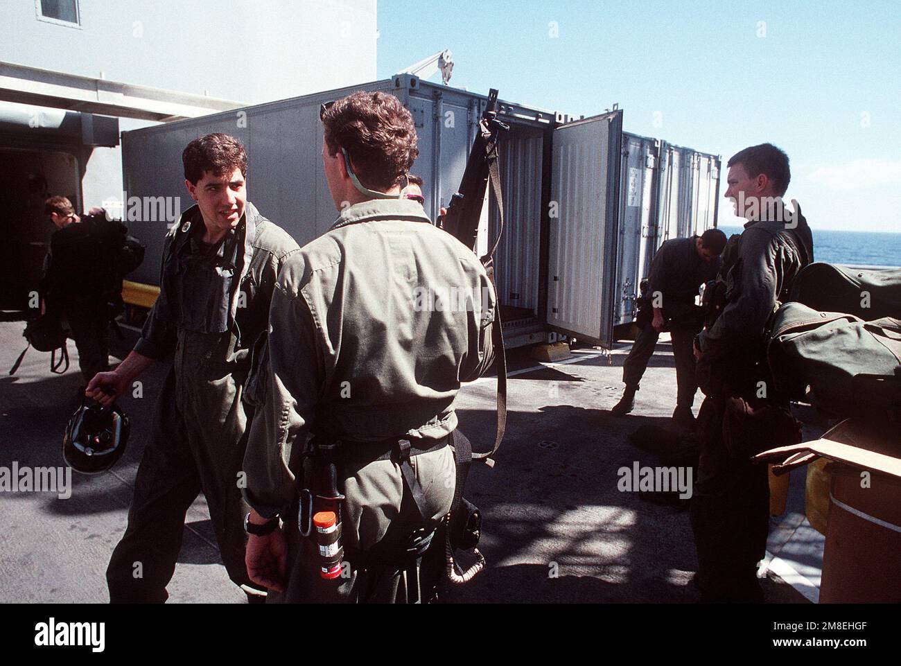 Members of Sea-Air-Land (SEAL) Team 8 draw their weapons and equipment ...