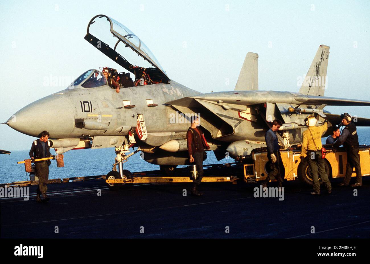 Flight deck personnel use an MD-3A tow tractor to move a Fighter ...