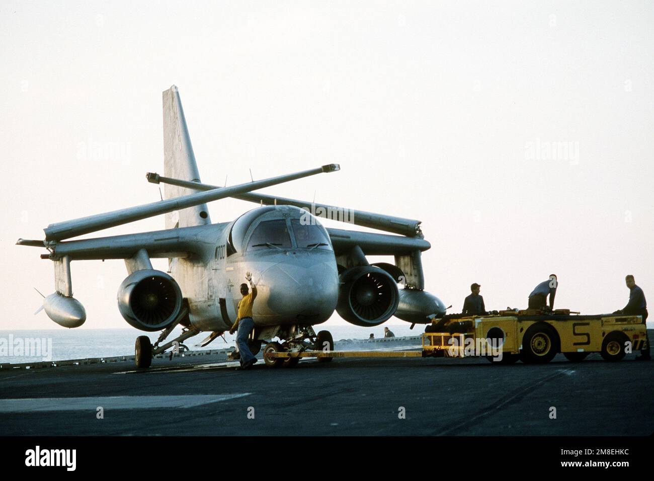 Flight deck personnel use an MD-3A tow tractor to respot an Air Anti ...