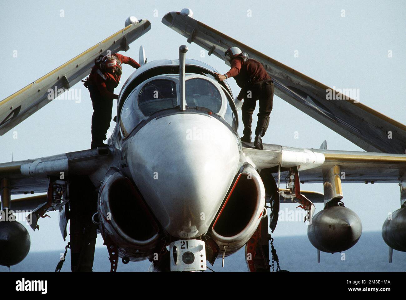 Maintenance personnel clean the canopy of an Attack Squadron 35 (VA-35 ...