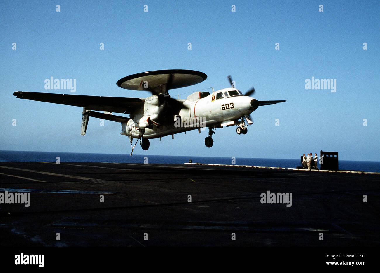 Landing signal officers (LSOs) watch as a Carrier Airborne Early ...