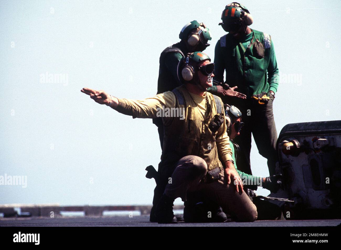 A catapult officer gives the launch signal to an aircraft as flight ...