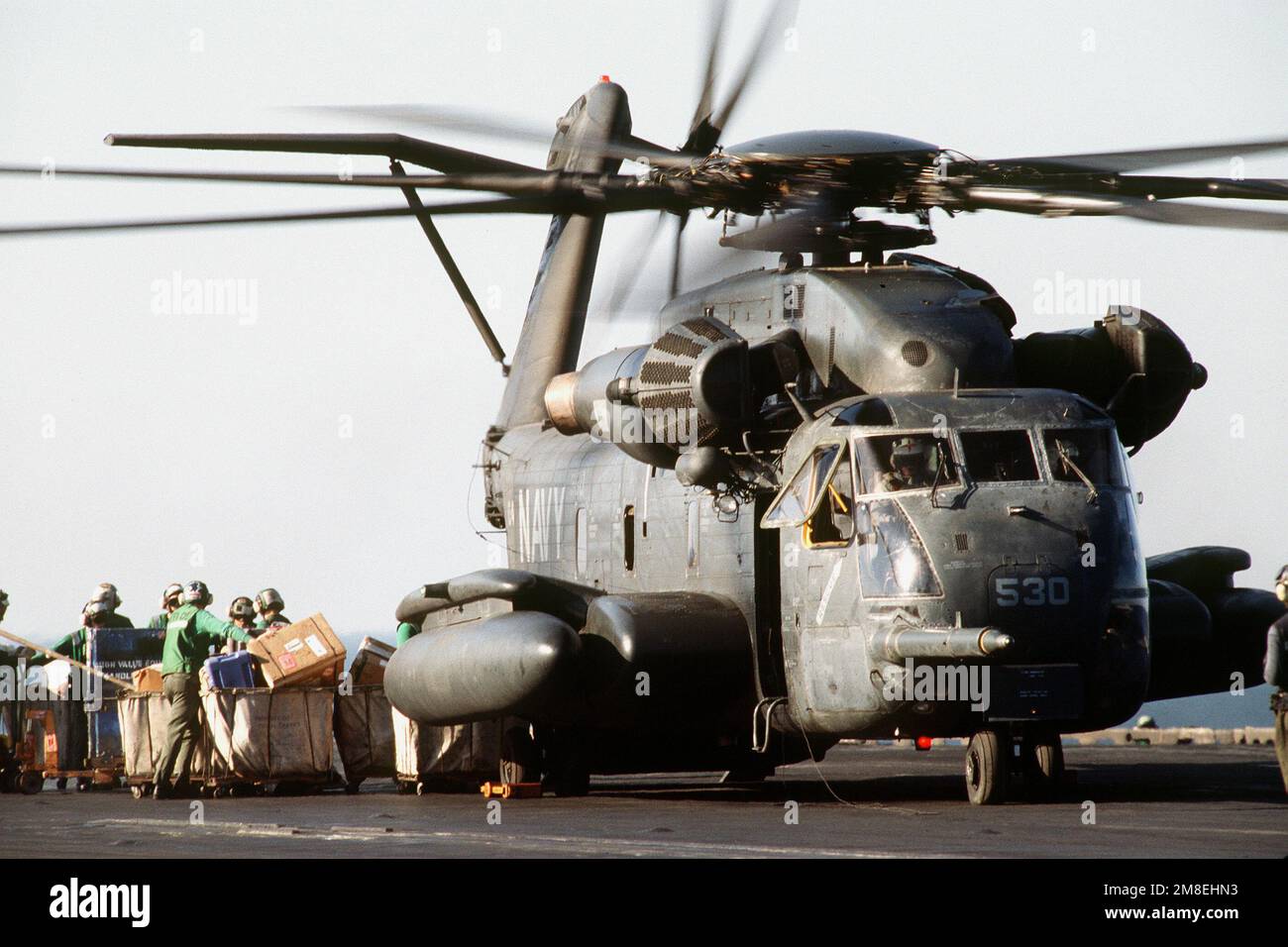 Flight deck crewmen load boxes onto a Helicopter Combat Support ...
