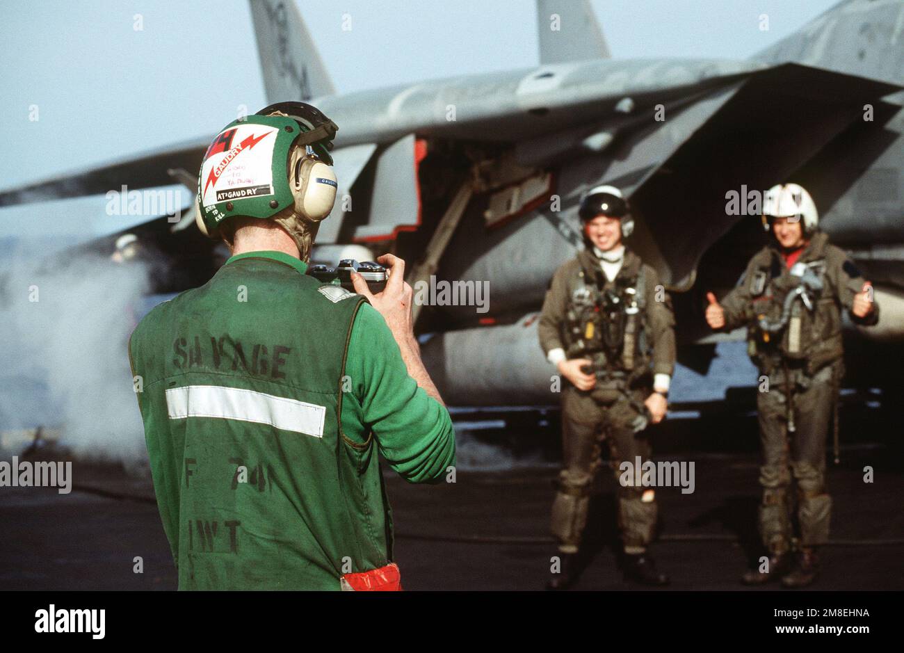 A squadron member photographs the pilot and radar intercept officer of a Fighter Squadron 74 (VF ...