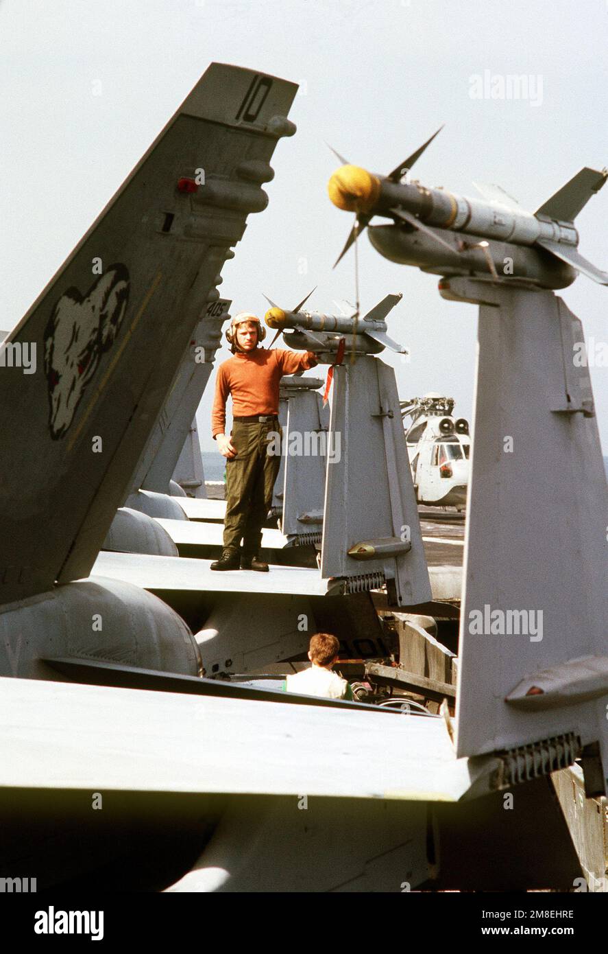 A plane captain from Strike Fighter Squadron 81 (VFA-81) checks out an ...