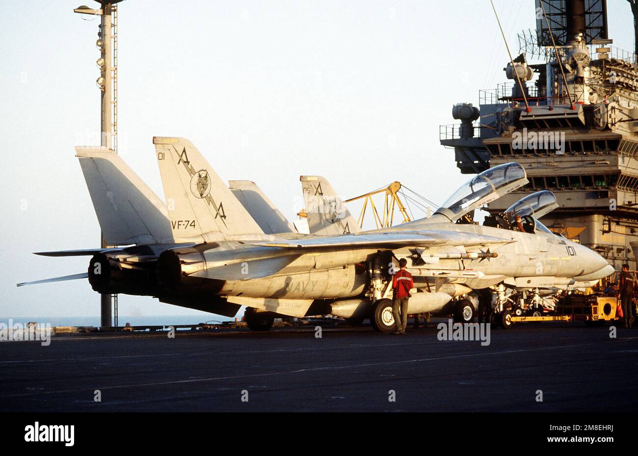 Aircraft handlers wait to move a Fighter Squadron 74 (VF-74) F-14A ...