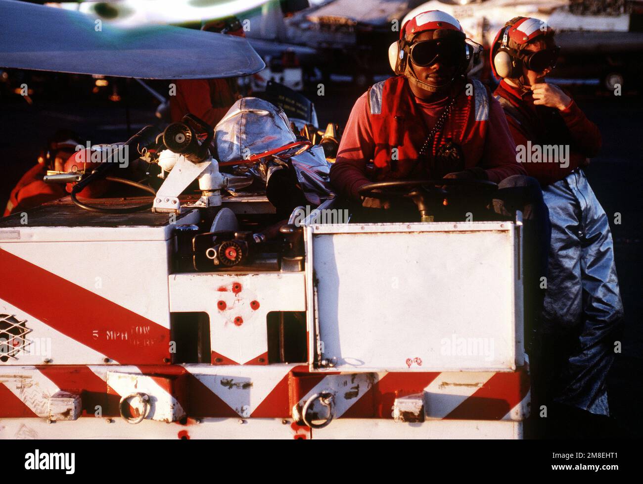 Members of the crash crew man a P-16 shipboard firefighting and rescue ...