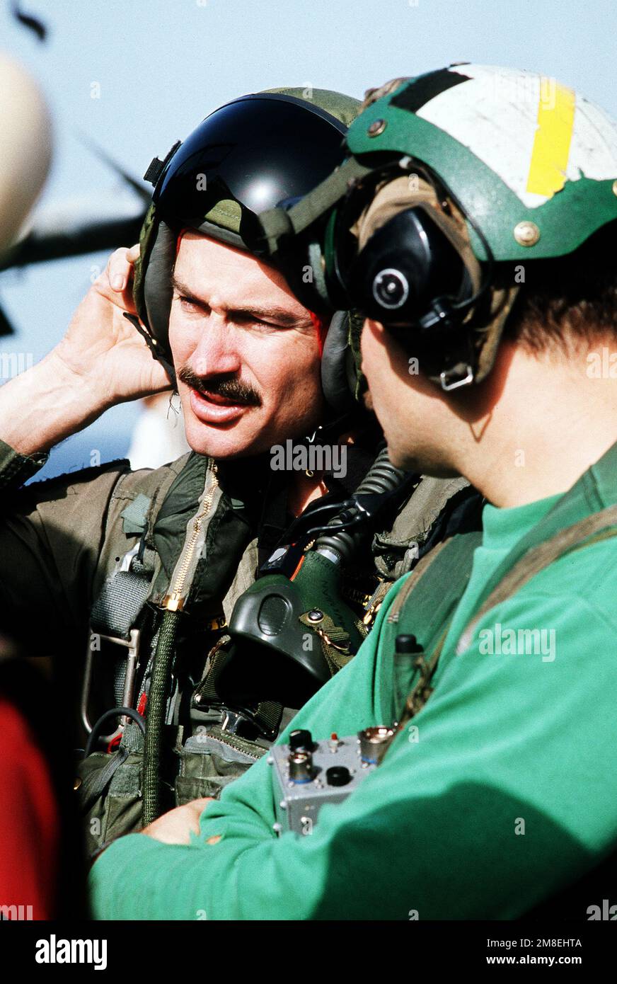 LT. CMDR. "Sox" Hanrahan of Fighter Squadron 103 (VF-103) talks with ...