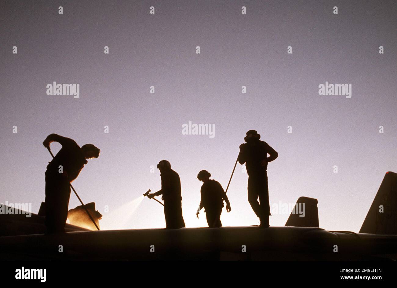 Maintenance crewmen wash down a Fighter Squadron 74 (VF-74) F-14A ...