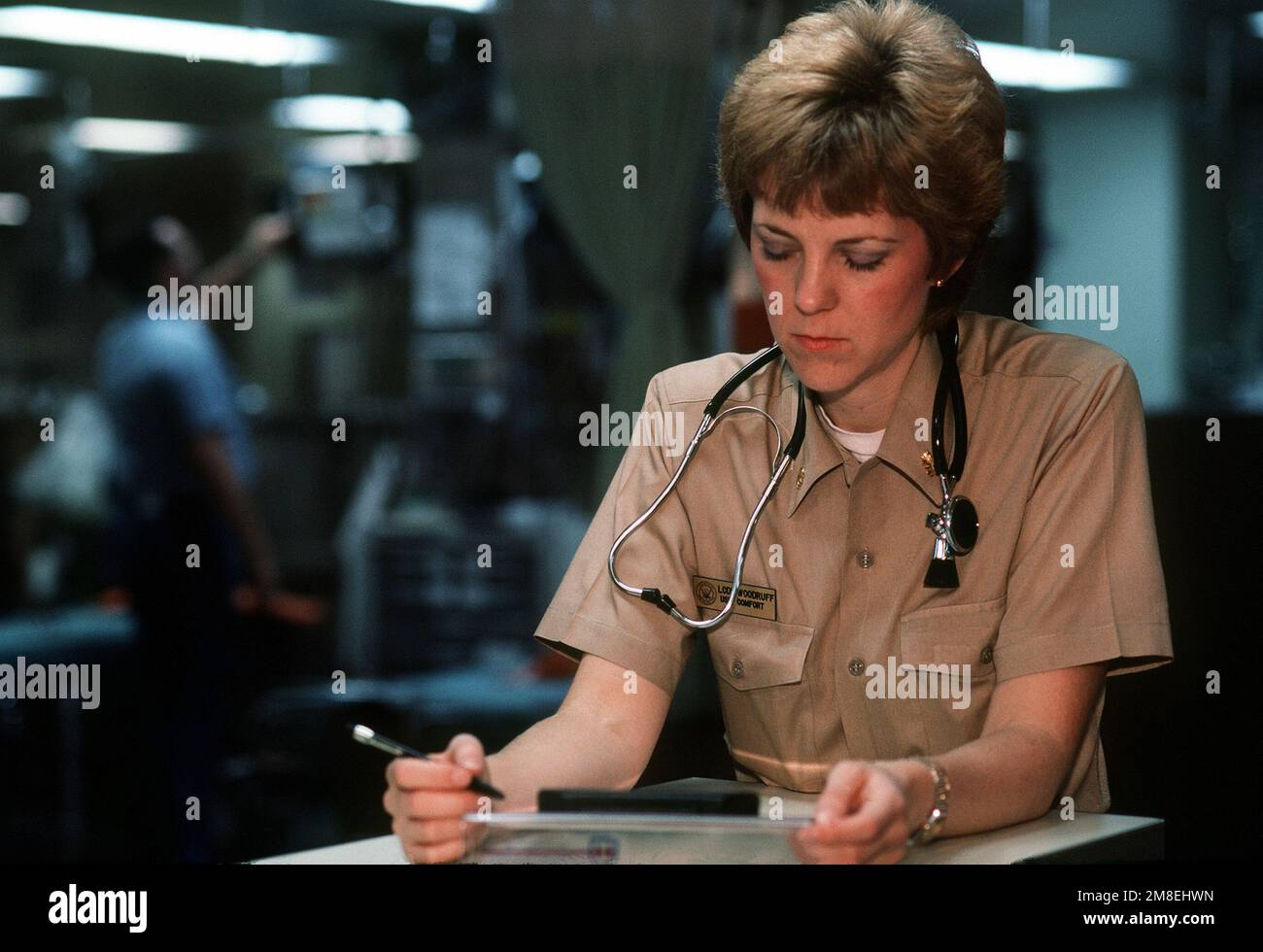 LT. CMDR. Julie Woodruff reviews paperwork in the casualty receiving ...