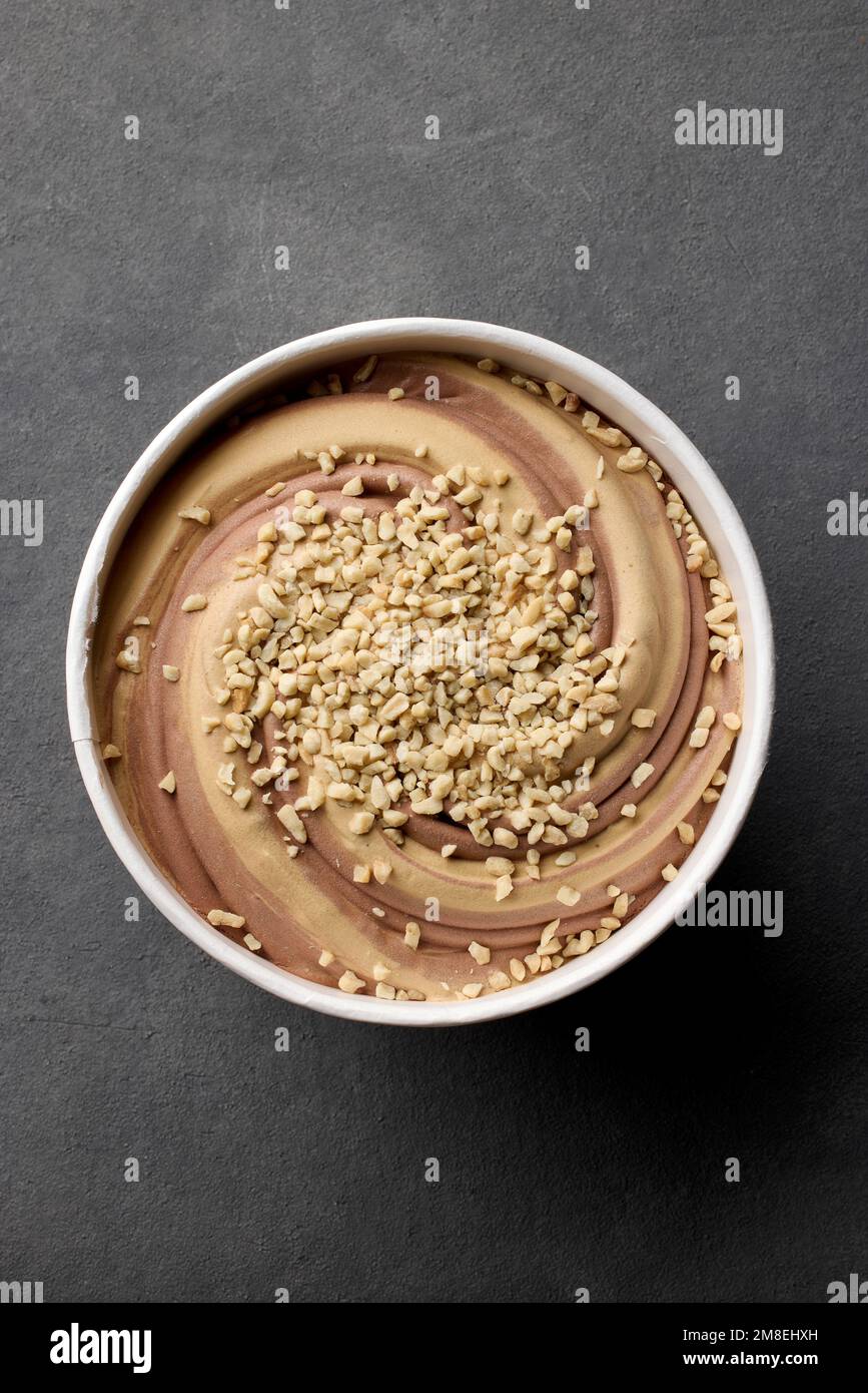 open caramel and chocolate ice cream package on dark grey background ...