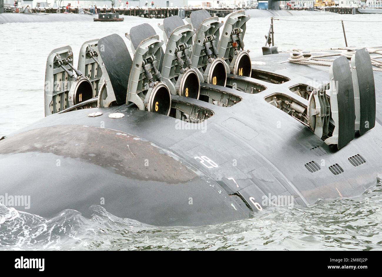 The hatches of the 12 vertical-launch Tomahawk missile tubes stand open ...