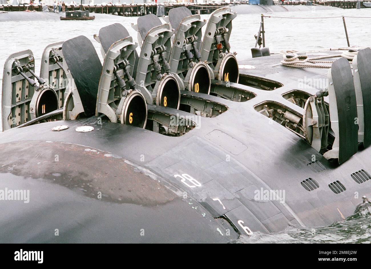 The hatches of the 12 vertical-launch Tomahawk missile tubes stand open ...