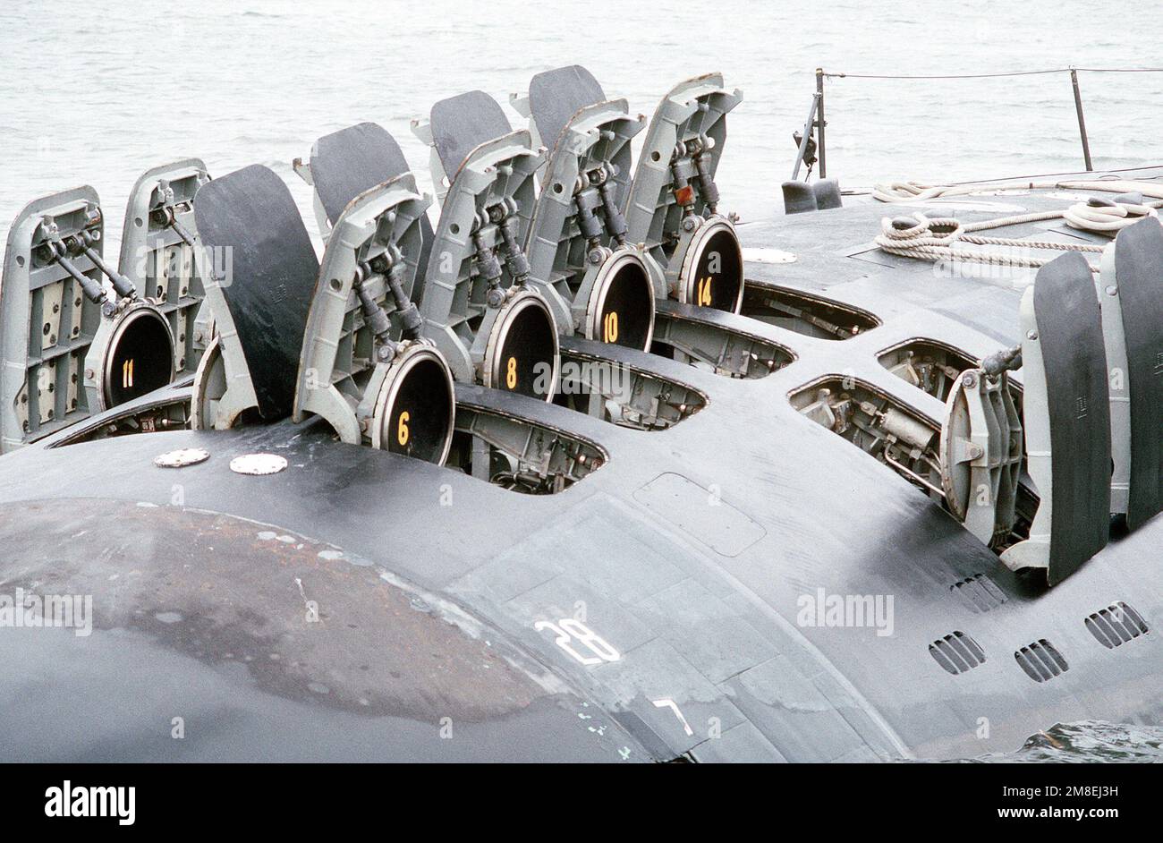 The hatches of the 12 vertical-launch Tomahawk missile tubes stand open ...