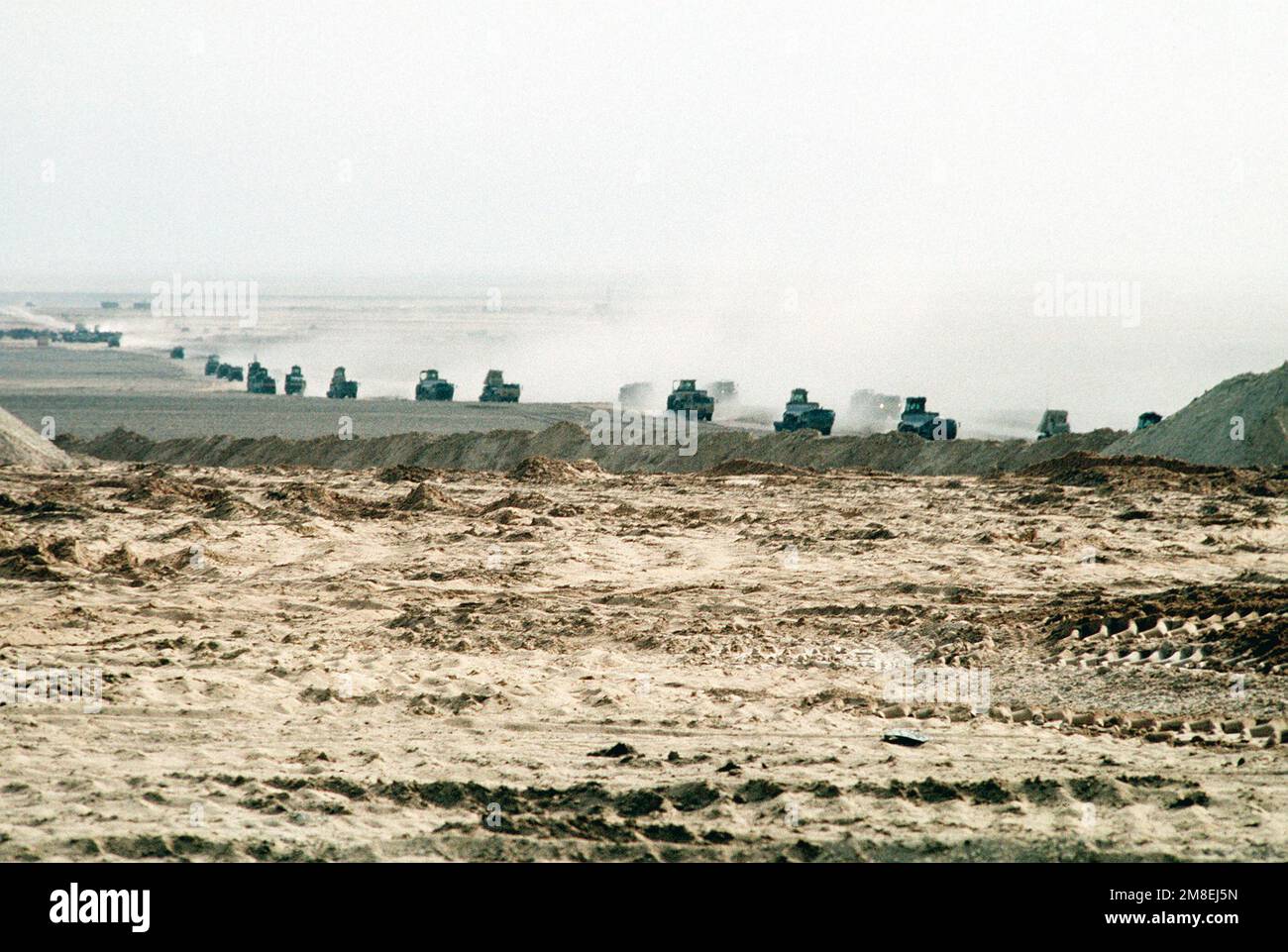 A convoy of heavy vehicles from Naval Mobile Construction Battalion ...