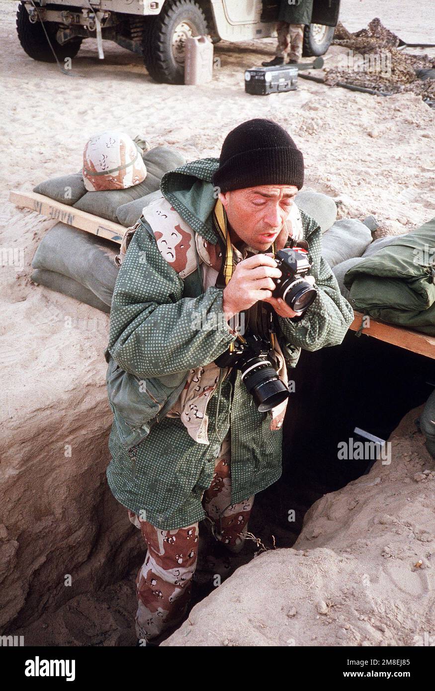 Combat photographer SGT. Earnie Grafton blows some dust off of one of ...