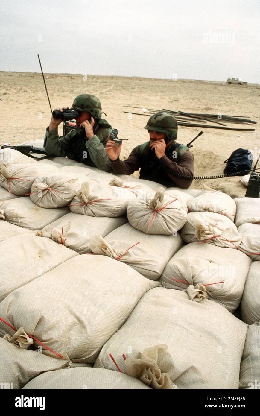 Two Seabees observe the surrounding area from a bunker in northern ...