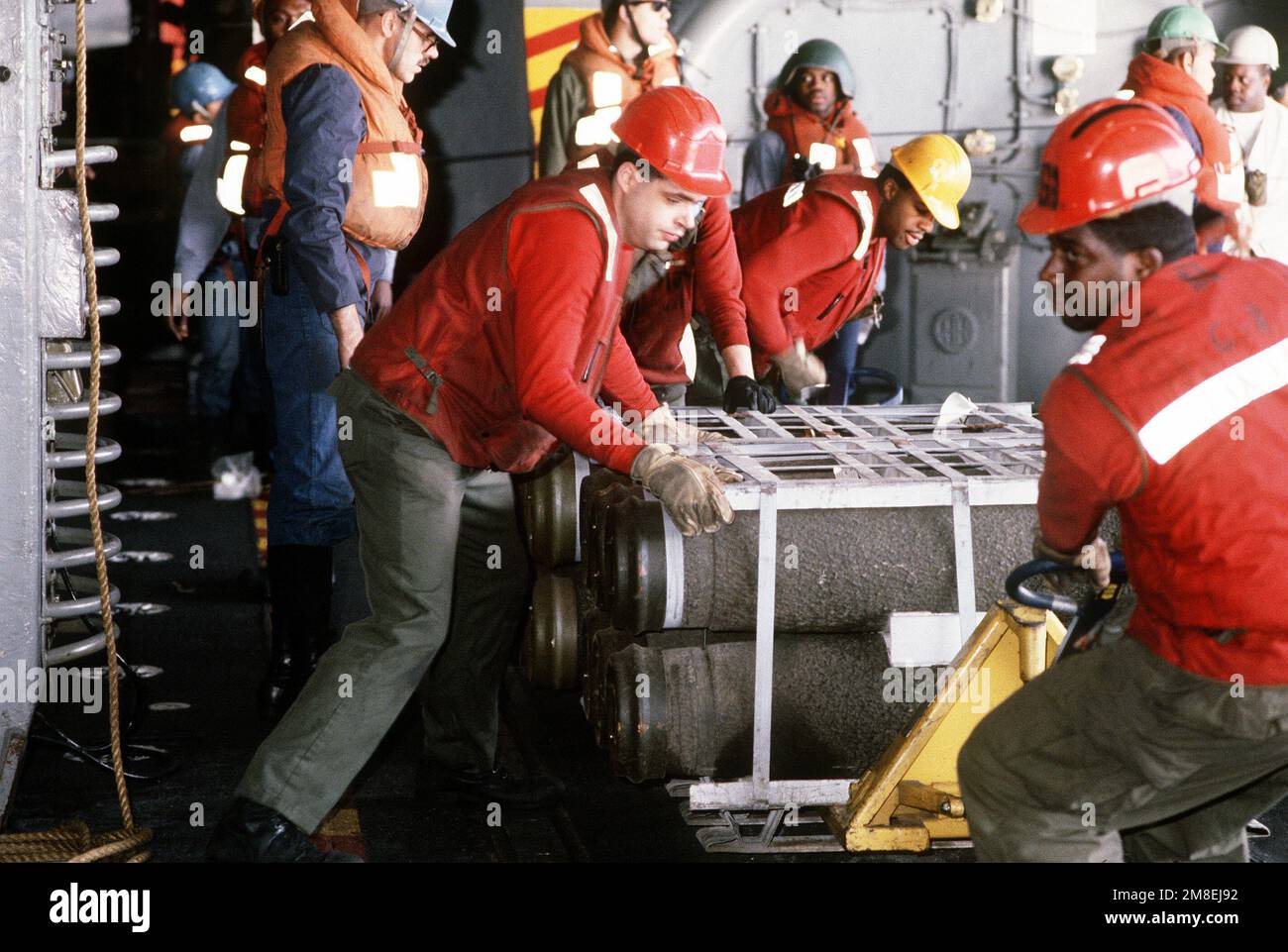 Ordnancemen haul away a pallet of Mark 82 500-pound bombs received ...